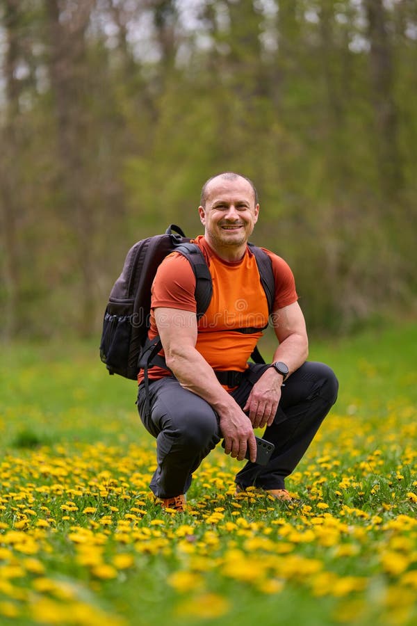 Man Squatting in Spring Meadow Stock Image - Image of hiking, healthy ...
