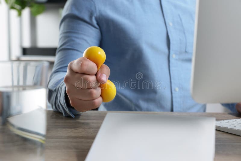 Man Squeezing Antistress Ball while Working with Computer in Office ...