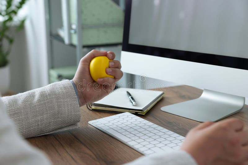Man Squeezing Antistress Ball while Working with Computer in Office ...