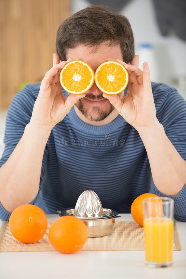 Man Squeezing Oranges Making Face with Orange Halves Stock Image ...