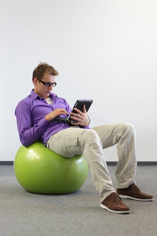 Man on Stability Ball Working with Tablet Stock Image - Image of back ...