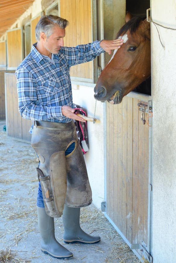 Man at stables stock image. Image of boots, middleaged - 258968533