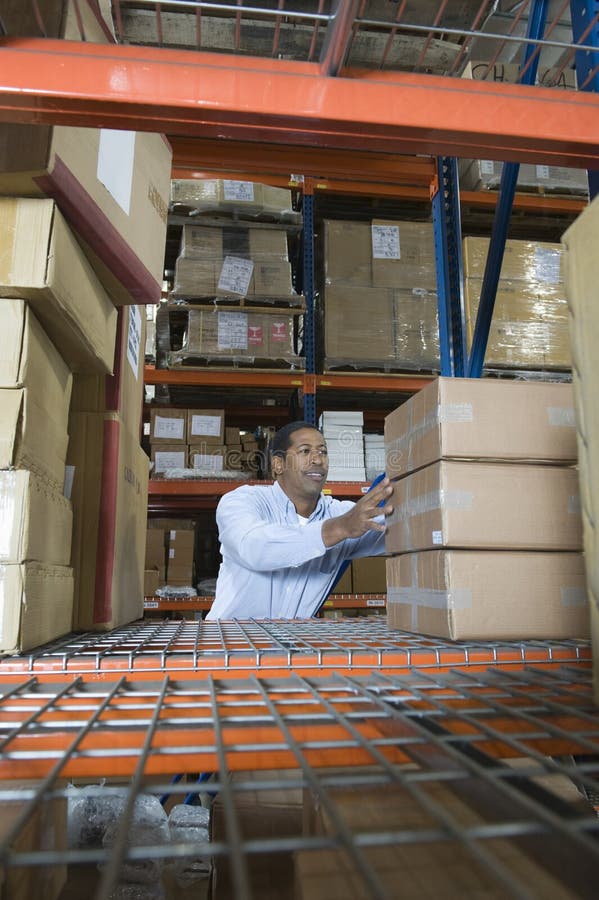 Man Stacking Boxes in Warehouse Stock Image - Image of inspecting ...