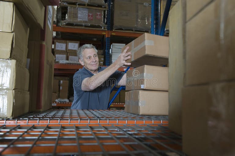 Man Stacking Boxes in Warehouse Stock Image - Image of baby, smiling ...