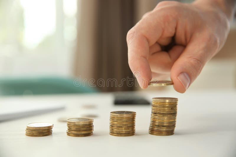 Man Stacking Coins on Table, Closeup. Savings Concept Stock Image ...