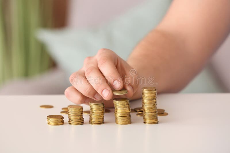 Man Stacking Coins on Table. Savings Concept Stock Photo - Image of ...