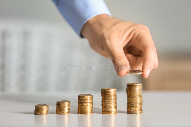 Man Stacking Coins on Table. Savings Concept Stock Image - Image of ...
