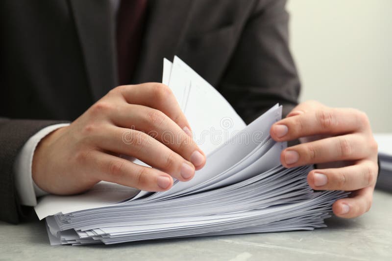 Man Stacking Documents at Table in Office, Closeup Stock Image - Image ...