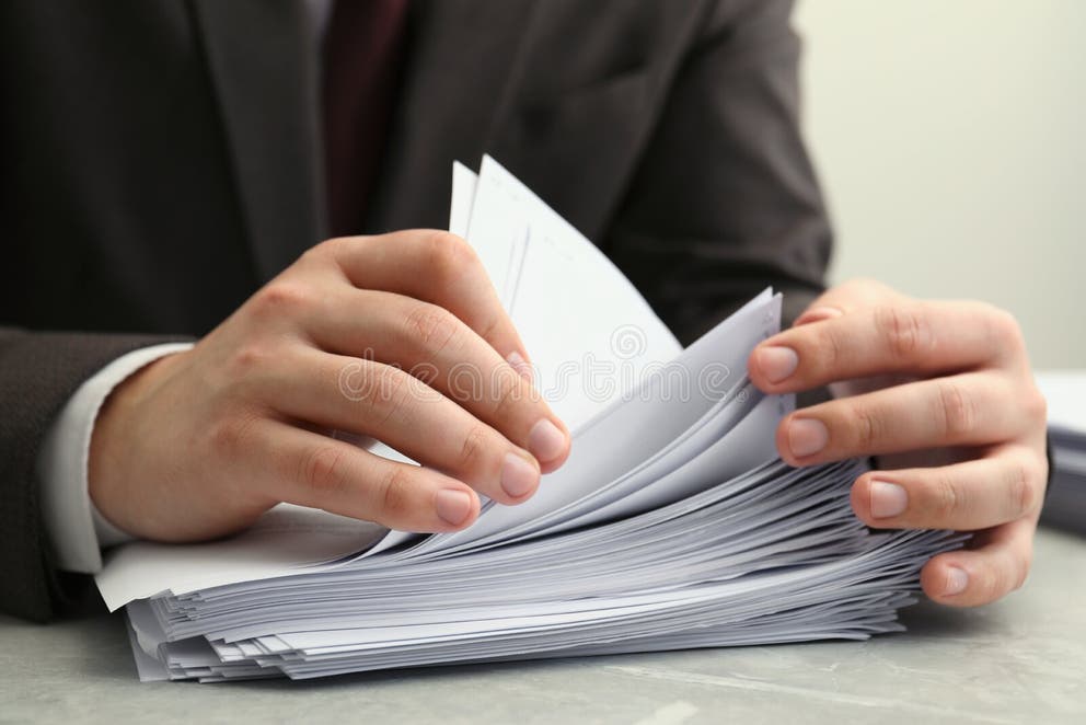 Man Stacking Documents at Table in Office, Closeup Stock Image - Image ...