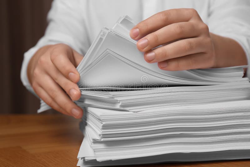Man Stacking Documents at Table in Office, Closeup Stock Image - Image ...