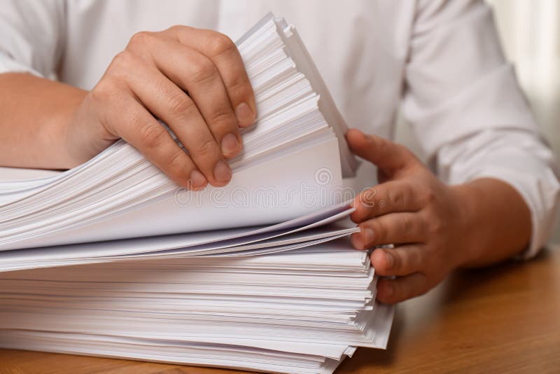 Man Stacking Documents at Table in Office, Closeup Stock Image - Image ...