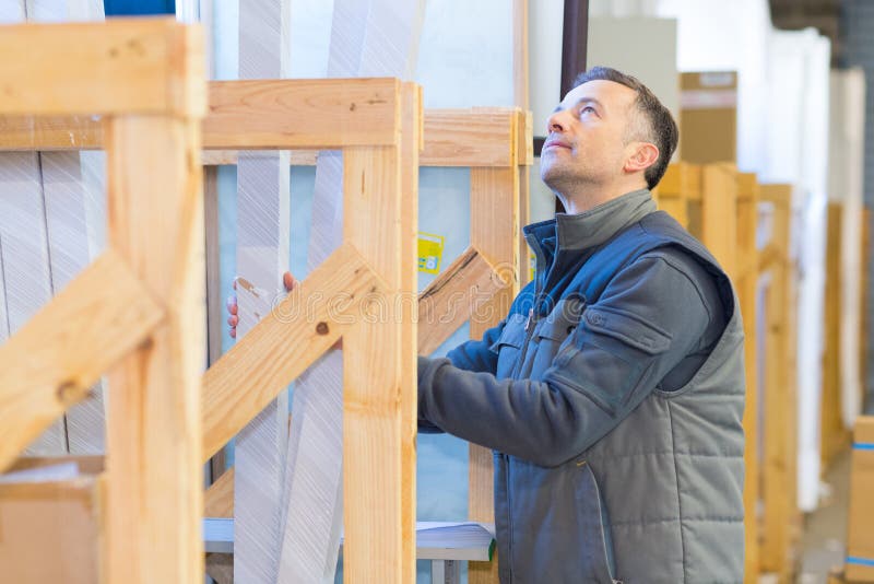 Man Stacking Materials in Wooden Racking Stock Photo - Image of store ...