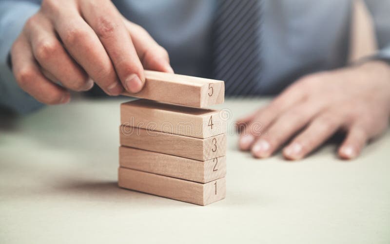 Man Stacking Wooden Blocks. Development Concept Stock Image - Image of ...