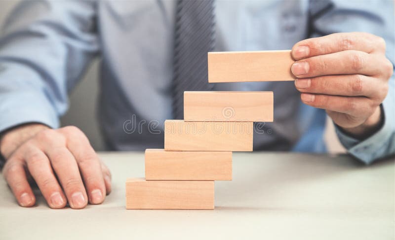 Man Stacking Wooden Blocks. Development Concept. Stock Photo - Image of ...