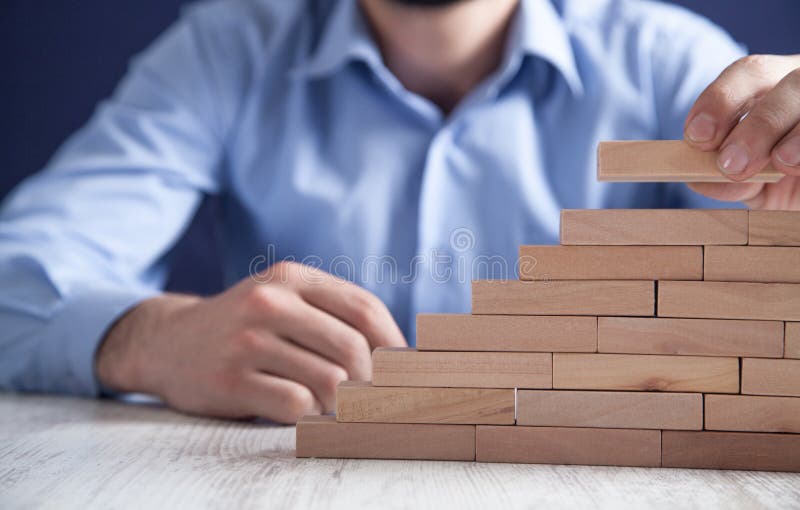 Man Stacking Wooden Blocks. Development Concept Stock Image - Image of ...