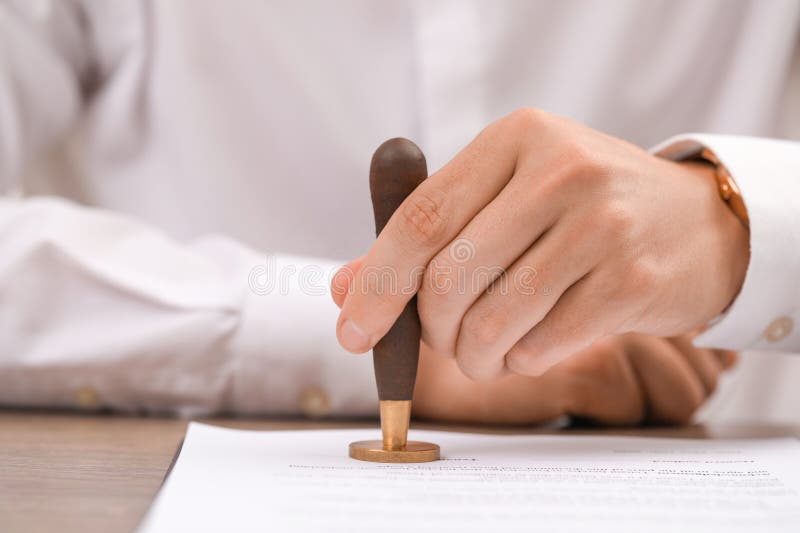 Man Stamping Document at Table, Closeup View Stock Photo - Image of ...
