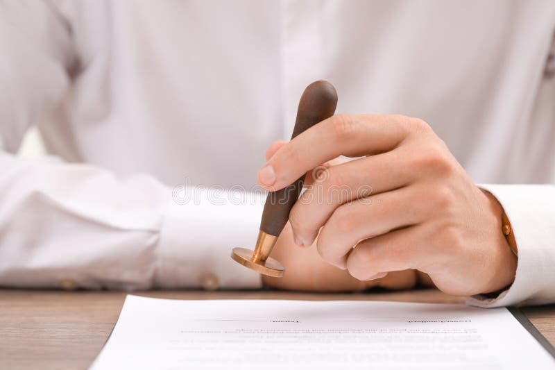 Man Stamping Document at Table, Closeup View Stock Image - Image of ...