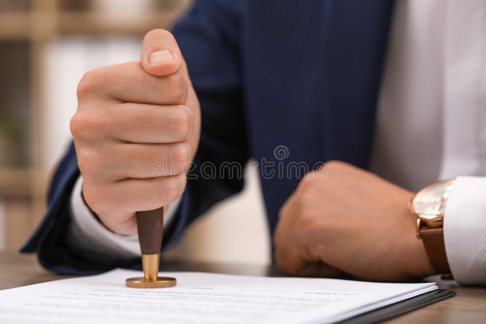 Man Stamping Document at Table, Closeup View Stock Photo - Image of ...