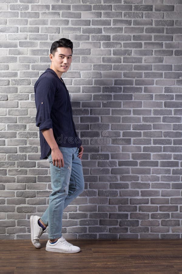 Man stand with brick wall stock image. Image of asian - 87479245