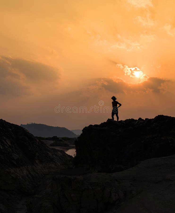 Man Stand on rocks stock photo. Image of highlands, male - 72146402