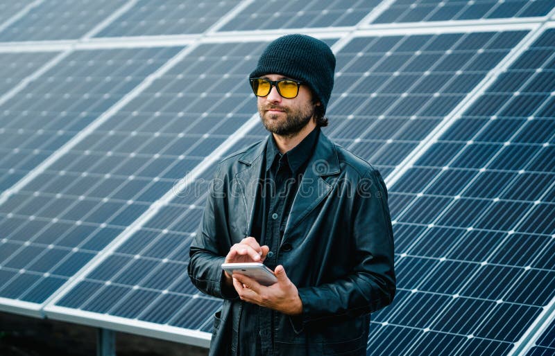 Man Stand beside of Solar Panels with Tablet in Hand and Make Notes ...