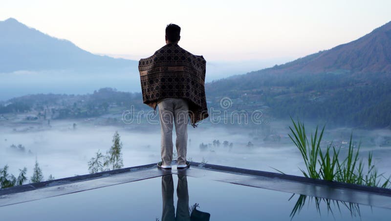 Man Standing Alone from Behind on the Edge of the Pool at Sunrise with ...