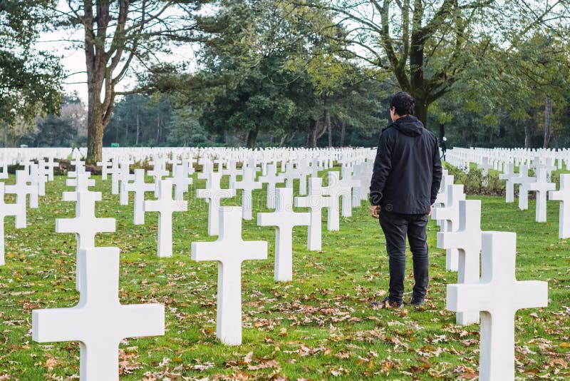 Man Standing Alone On A Graveyard Full Of Crosses. Blank Cross. Stock ...