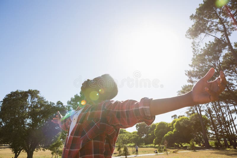 Man Standing with Arms Outstretched in the Park Stock Photo - Image of ...