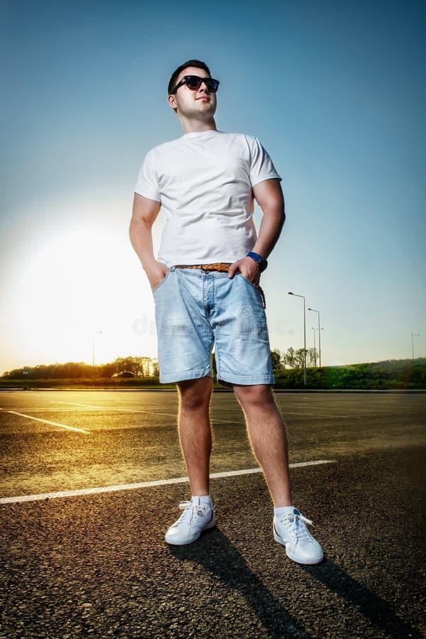 Man Standing on the Asphalt Road at Sunset Stock Image - Image of ...