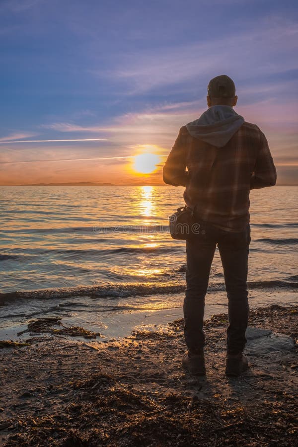 Man Standing Backlight Sunset Lighting Back View at Evening Beach in a ...