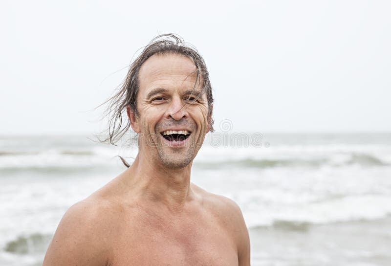 Man Standing at Beach Smiling Stock Image - Image of handsome, peaceful ...