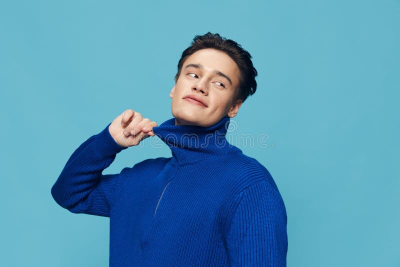 Man is Standing in Blue Zip-up Sweater Pulling the Collar Aside and ...
