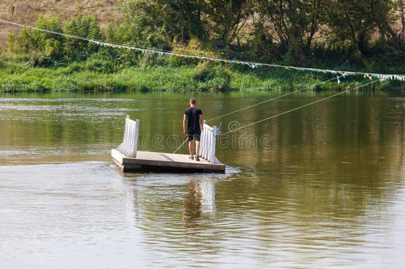 A Man is Standing on a Boat in the Water Stock Image - Image of green ...