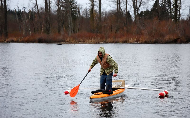 Man Standing in Canoe stock photo. Image of standing - 25524352