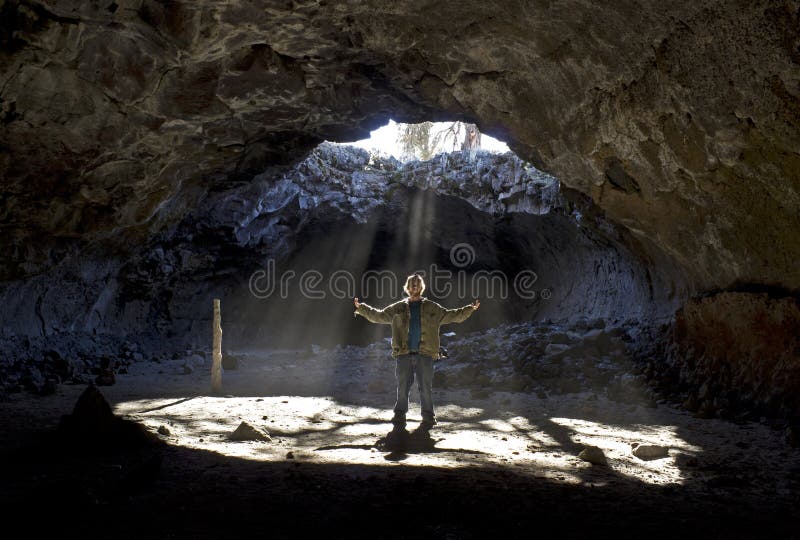 Man Standing in Cave Sunbeams Stock Photo - Image of geology ...