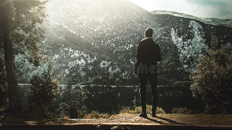 Man Standing on Cliff stock photo. Image of mountain - 109929864