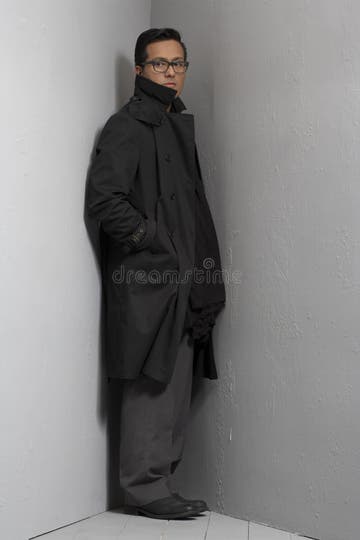 Man Standing in Corner with Trench Stock Photo - Image of brunette ...