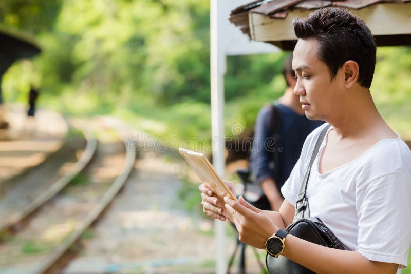 Man Standing with Digital Tablet and Bag Waiting for Train Stock Photo ...
