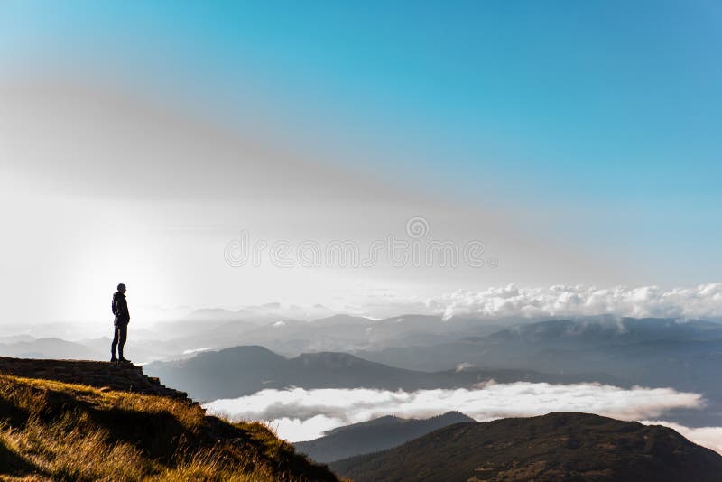 Man Standing at the Edge of the Cliff Looking at Mountains Stock Image ...