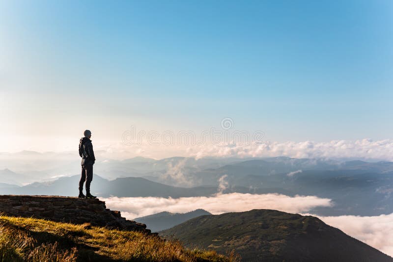 Man Standing at the Edge of the Cliff Looking at Mountains Stock Image ...