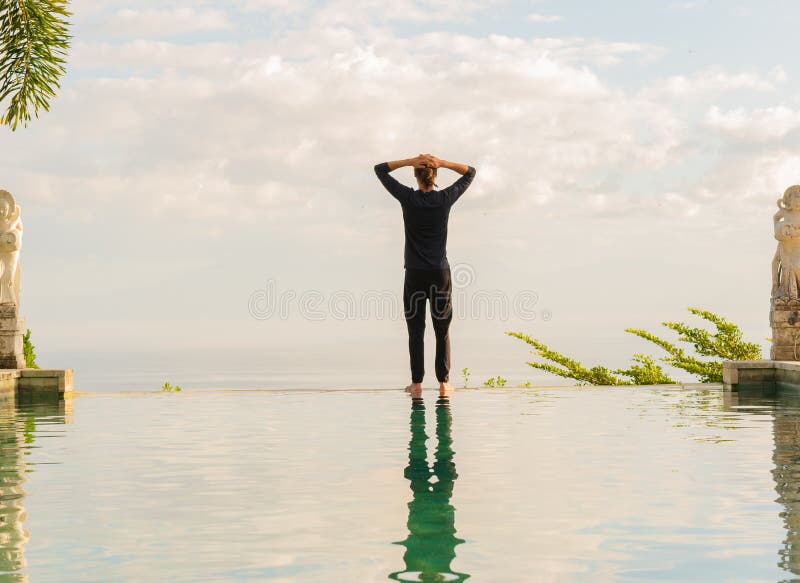 A Man Standing at the Edge of Infinity Pool Stock Image - Image of calm ...