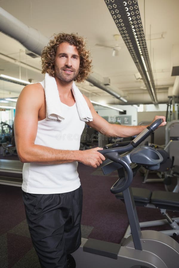 Man Standing by Exercise Bike at Gym Stock Image - Image of indoors ...