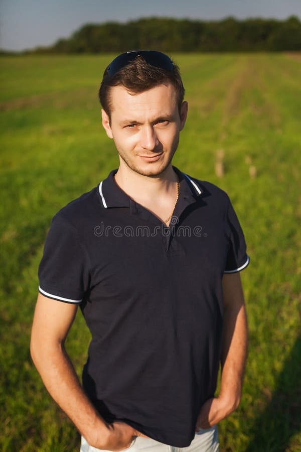 Man Standing in a Field on the Grass Stock Photo - Image of caucasian ...