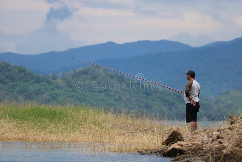 A Man Standing Fishing on Wild Editorial Stock Image - Image of ...