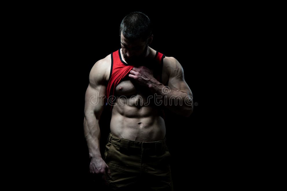 Man Standing and Flexing Muscles on Black Background Stock Photo ...