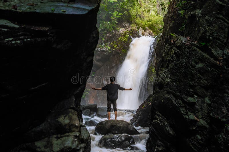 Man Standing in Front of Beautiful Waterfall. Beautiful Landscape with ...