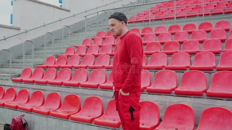 Man Standing in Front of Empty Stadium. a Man Stands Alone in Front of ...