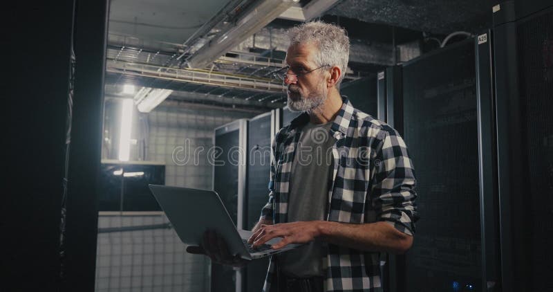 Man Working on Laptop in Server Room Stock Video - Video of coding ...