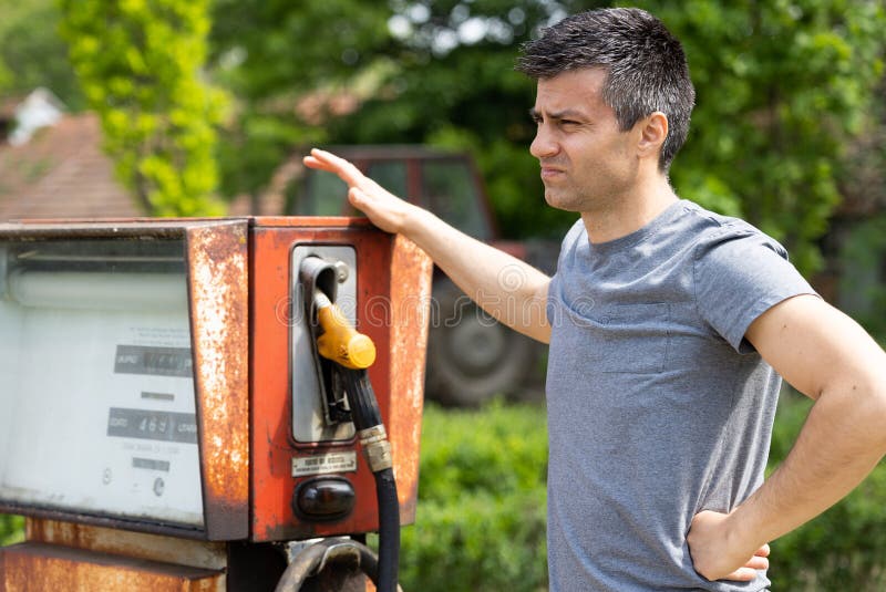 Man Standing beside Gasoline Pump Out of Service Stock Image - Image of ...