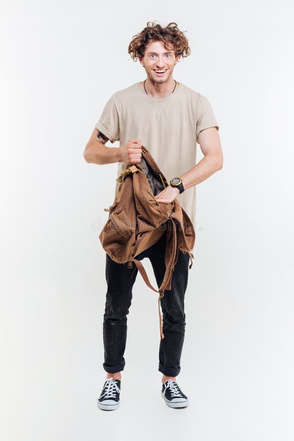 Man Standing And Getting Something Out Of His Backpack Stock Image ...